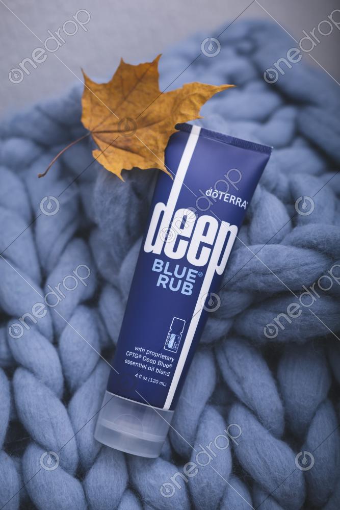 Calming lotion dōTERRA Deep Blue Rub in tube on soft knit m by Kseniia Che