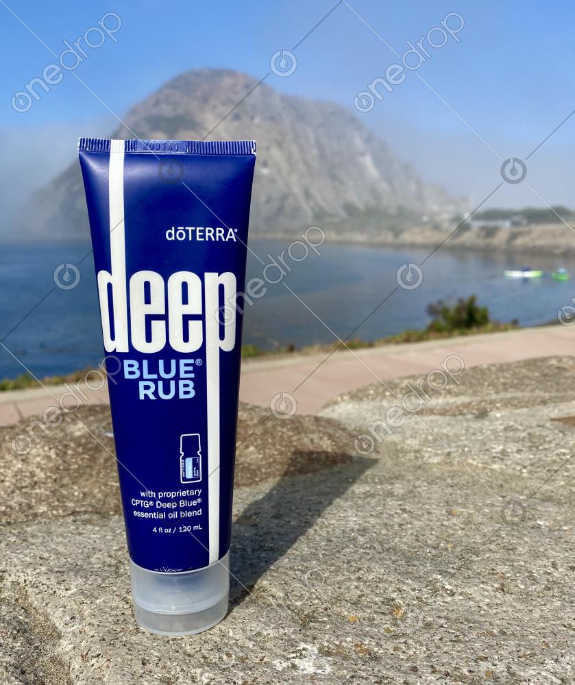 dōTERRA Deep Blue framed by the ocean at Morro Rock by Robert Griego